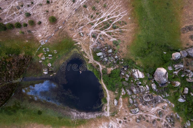 Aerial Shot of a Field with Rocks and a Lagoon. Stock Photo - Image of ...