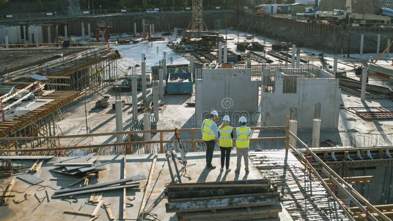 Aerial Shot of a New Constructions Development Site with Diverse Team of Engineers and ...