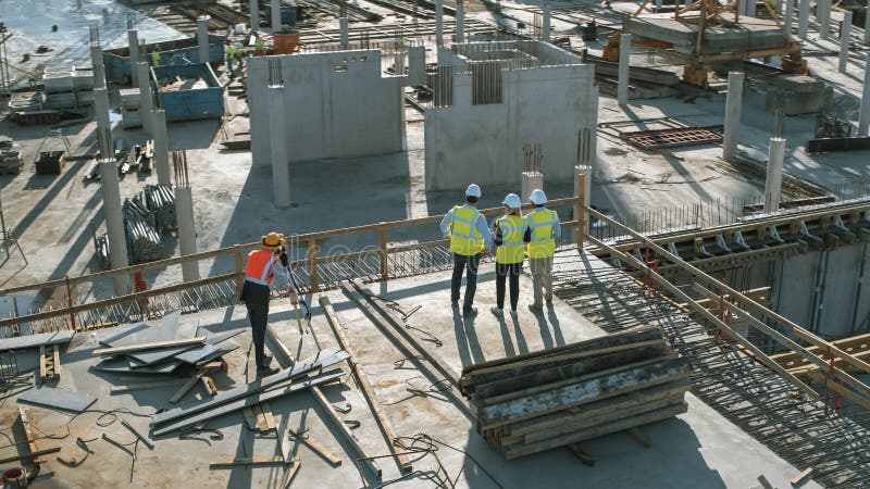 Aerial Shot of a New Constructions Development Site with Diverse Team of Engineers and ...