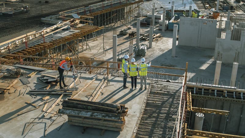 Aerial Shot of a New Constructions Development Site with Diverse Team of Engineers and ...