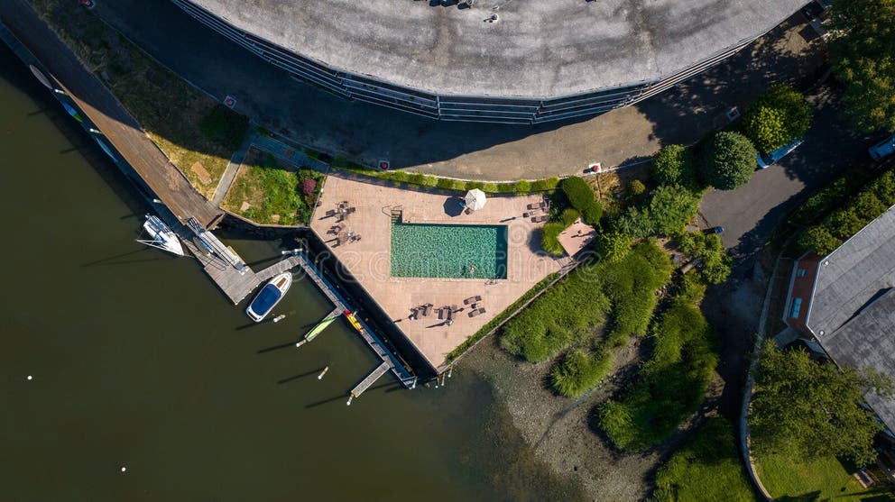 Aerial Shot of a Pool by a Pier Surrounded by Trees Stock Photo - Image ...
