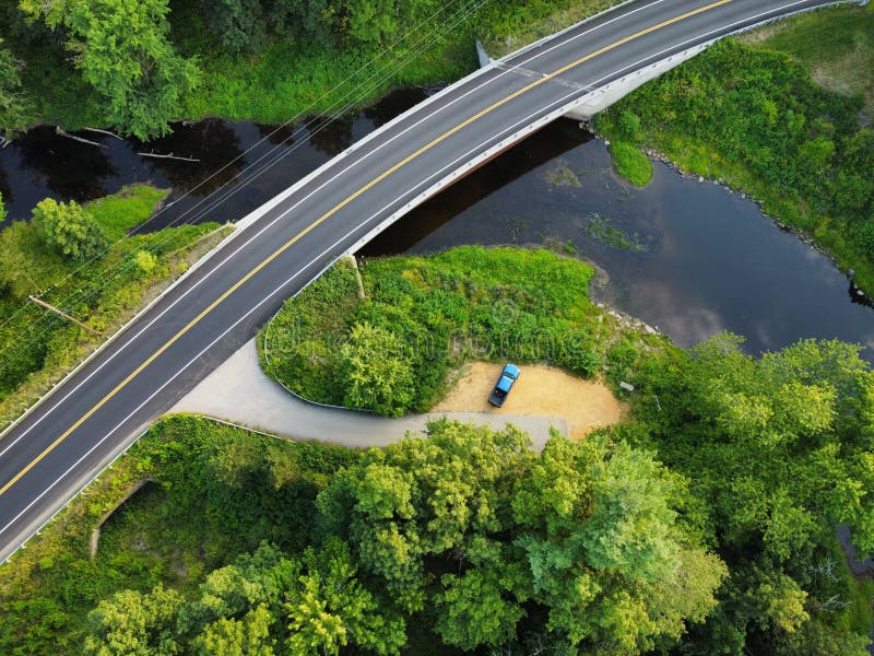 Aerial Shot of a Road Over a Lake Surrounded by Trees Stock Photo ...