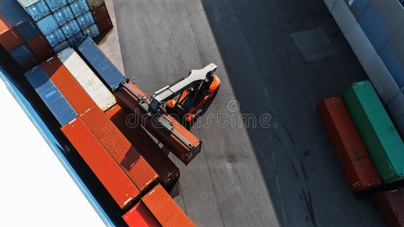 Aerial Top Down Shot of a Container Handler Carrying a Large Red Cargo ...