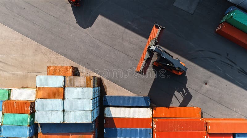 Aerial Top Down Shot of a Container Handler Carrying a Large Red Cargo ...