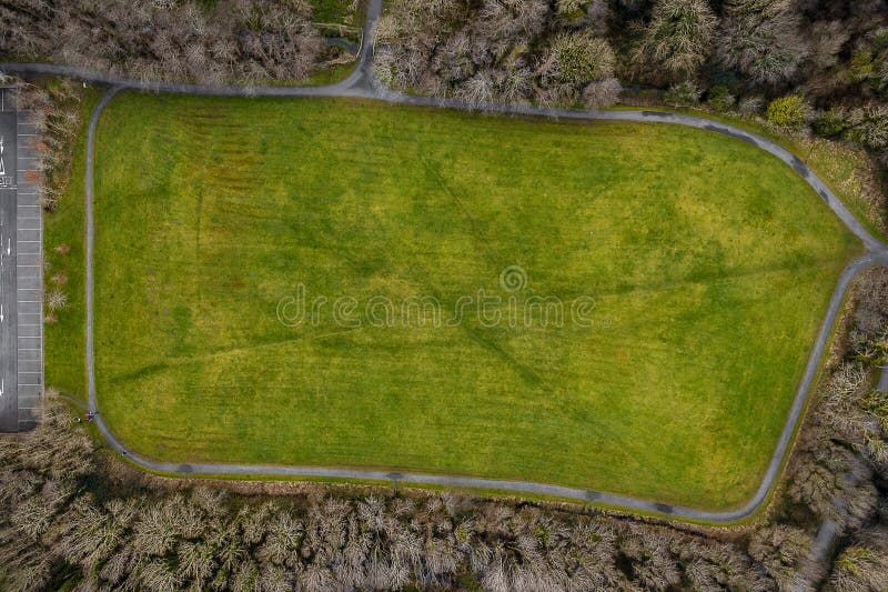 Aerial Top Down View on a Green Grass Field in a Park with Walking Path ...