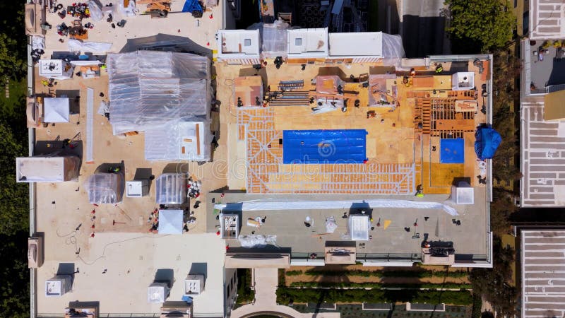 Aerial Top-down View of Rooftop Construction Site with Workers and ...