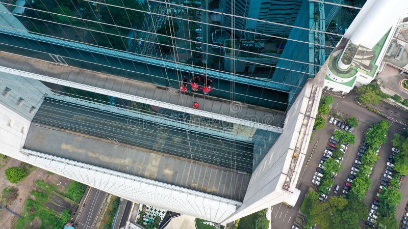 Aerial Top Down View of Window Cleaners Working on a Glass Facade ...
