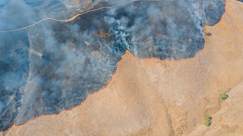 Aerial Top Shot Burning Black Vegetation Approaching the Sand Stock ...