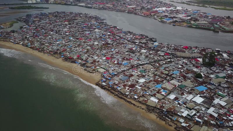 Aerial Tracking Above Massive Slum on Beach Stock Video - Video of ...