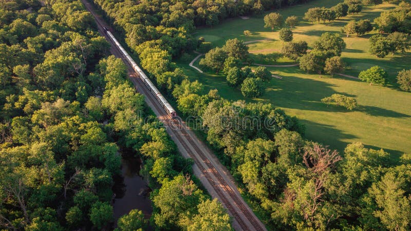 Aerial of a Train Driving Along Tracks Surrounded by a Splendid Natural ...