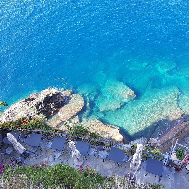 Aerial of Underwater Stones Near the Beach with a Cafe on the Balcony ...