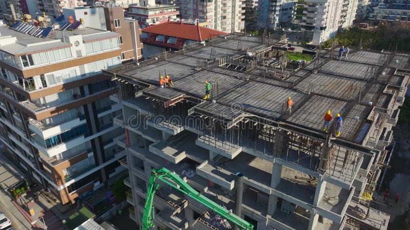 Aerial Video: Workers Installing Metal Framework and Pouring Concrete ...