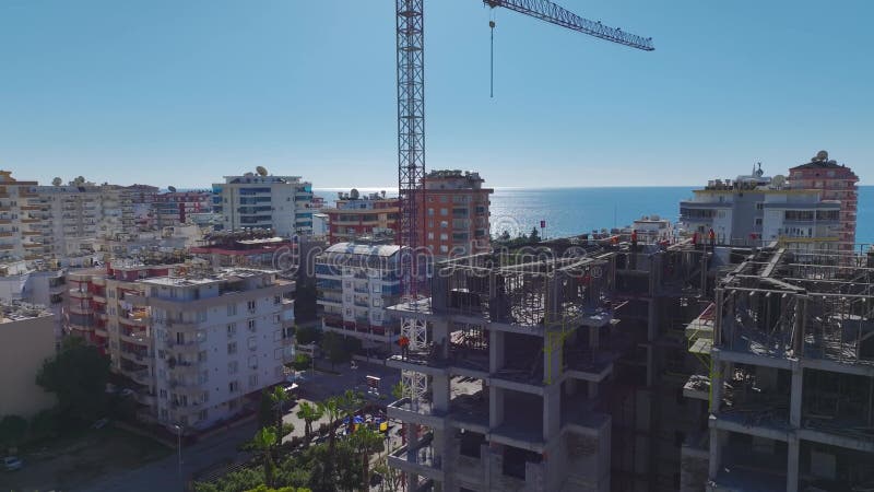 Aerial Video: Workers Operating Cranes and Pouring Concrete on a Multi ...