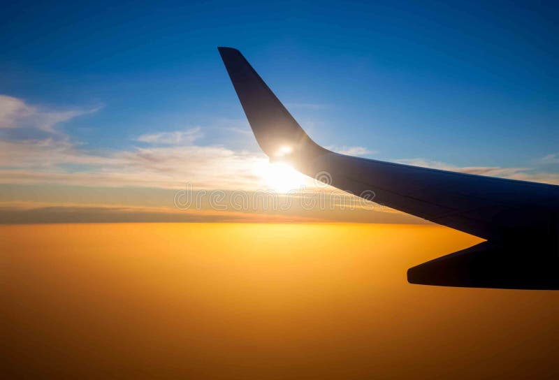 Aerial View of an Airplane Flying in the Sunset Sky Stock Photo - Image ...