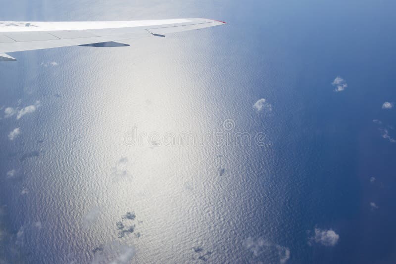 Aerial View of Airplane Wing Over Blue Tropical Ocean Stock Photo ...