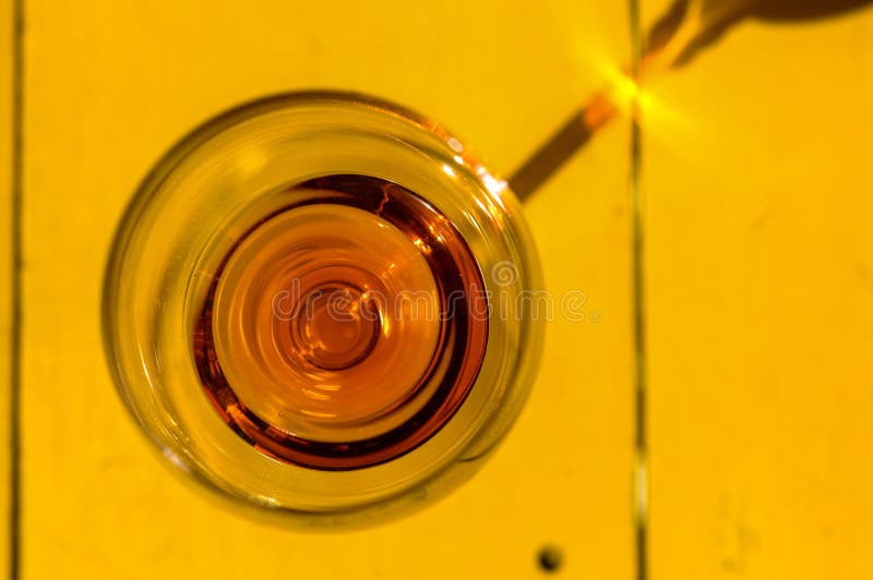 Amber Liquid in Crystal Glass on Blue Background. Stock Photo - Image ...
