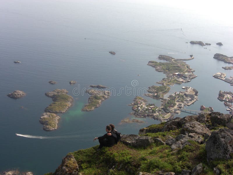 Aerial View of the Arctic Ocean and Two People Resting on a Cliff Stock ...