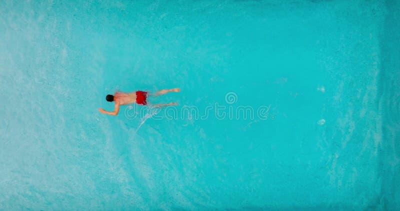 Aerial View As a Man Dives into the Pool and Swims. Stock Footage ...