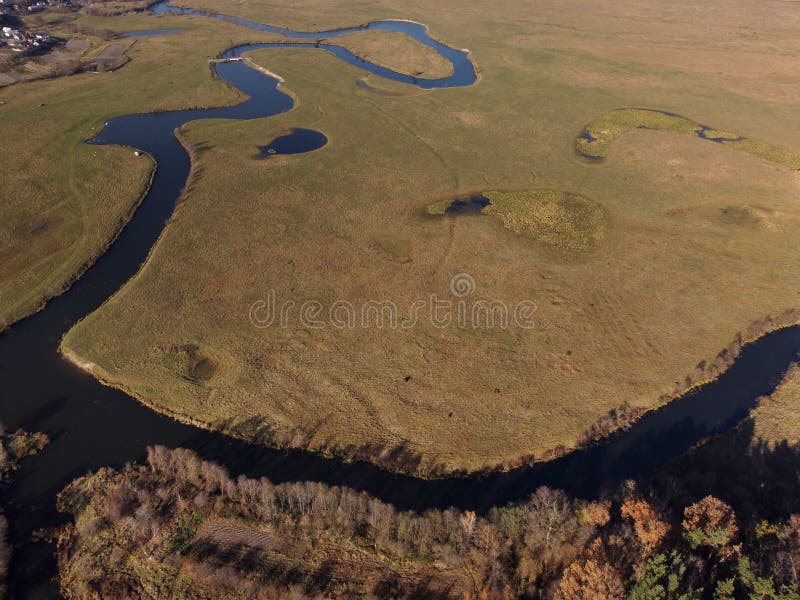 Aerial View of a Beautiful Winding River Flows among the Fields, Which ...