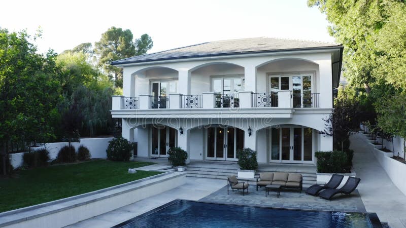 Aerial View of a Big House Surrounded by Trees with a Pool in the ...