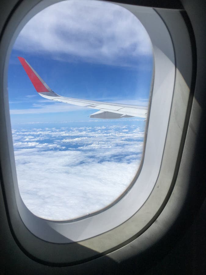 Aerial View of Blue Sky and Cloud Space through an Airplane Window ...