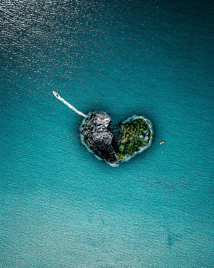 Aerial View of a Boat Breaking a Heart-shaped Island Stock Image ...