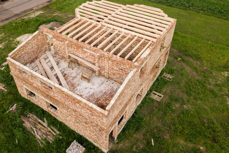 Aerial View of a Brick House with Wooden Ceiling Frame Under ...