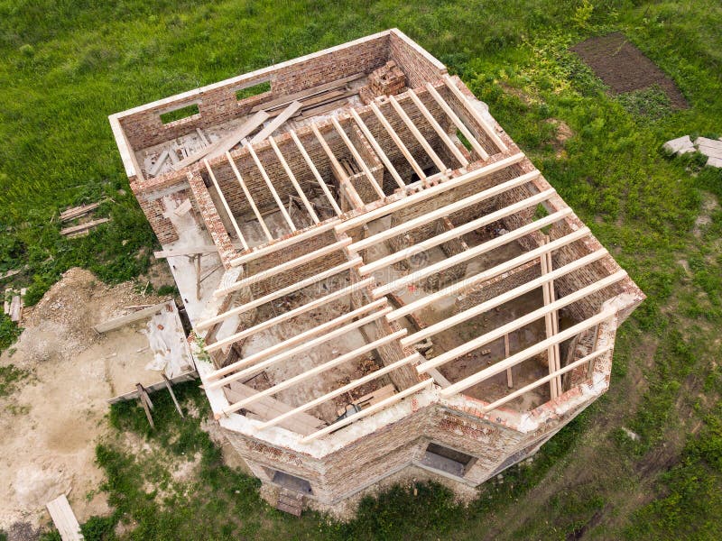 Aerial View of a Brick House with Wooden Ceiling Frame Under ...