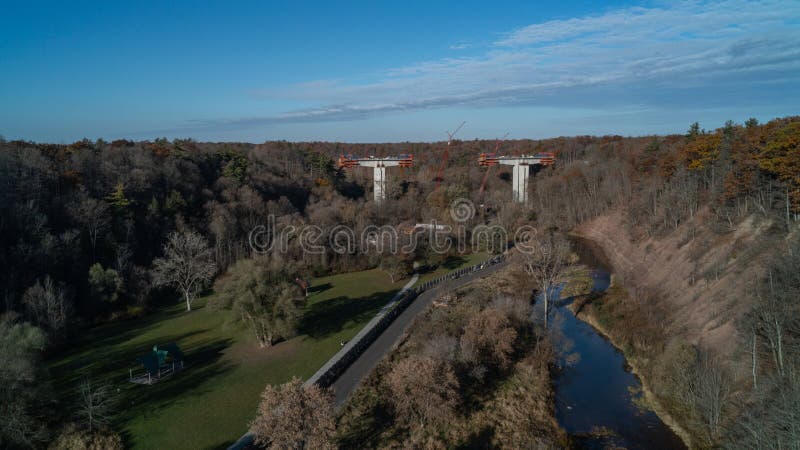 An Aerial View of a Bridge Being Built Over a Valley Stock Photo ...