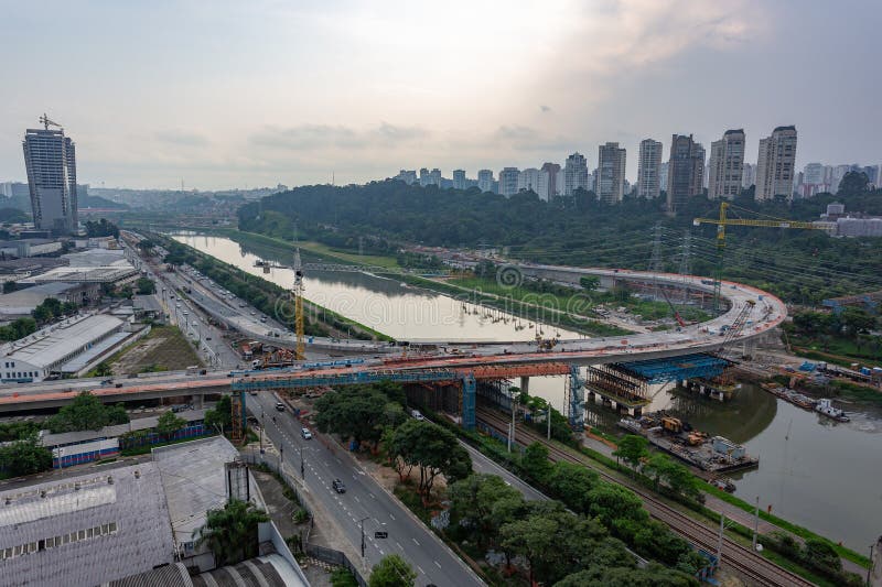 Bridge Under Construction Seen from Above, with River and Buildings in ...