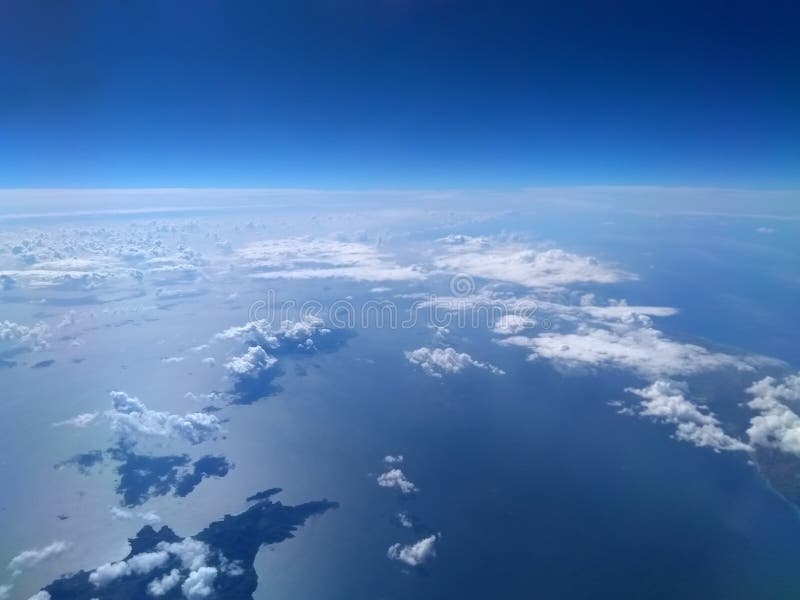Aerial View of Bright Blue Sea and Sky with White Clouds Casting ...