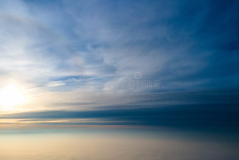Aerial View of Bright Yellow Sunset Over White Dense Clouds with Blue ...