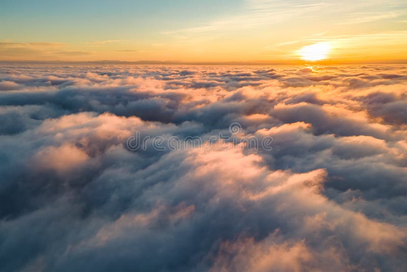 Aerial View of Bright Yellow Sunset Over White Dense Clouds with Blue ...