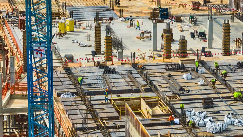 Aerial View of Bustling Construction Site with Crane and Workers in ...