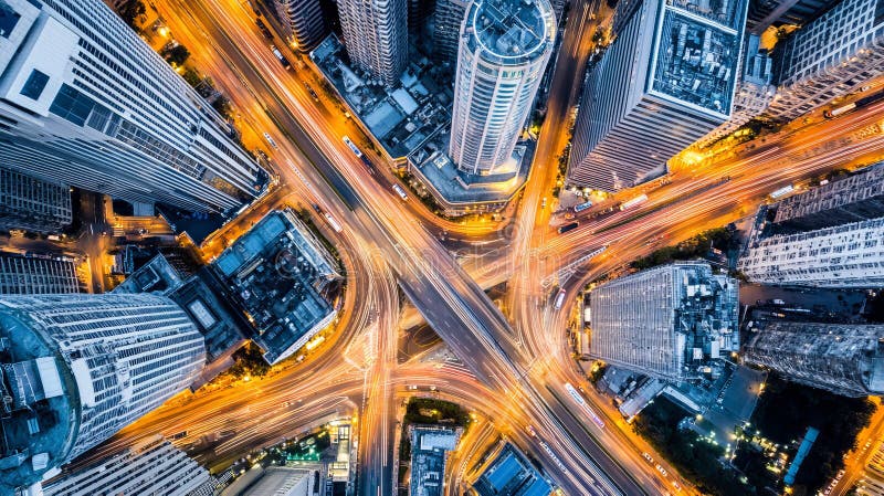 Aerial View of a Bustling Urban Intersection Lit Up by Neon Lights at ...