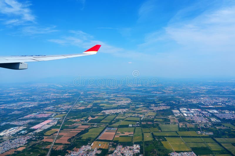 Aerial View Capturing the Lush Green and Golden Fields Below, with a ...