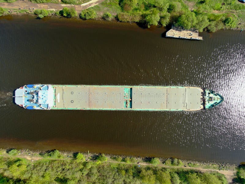 Aerial View the Cargo Ship Floats Down the River Surrounded by Forest ...