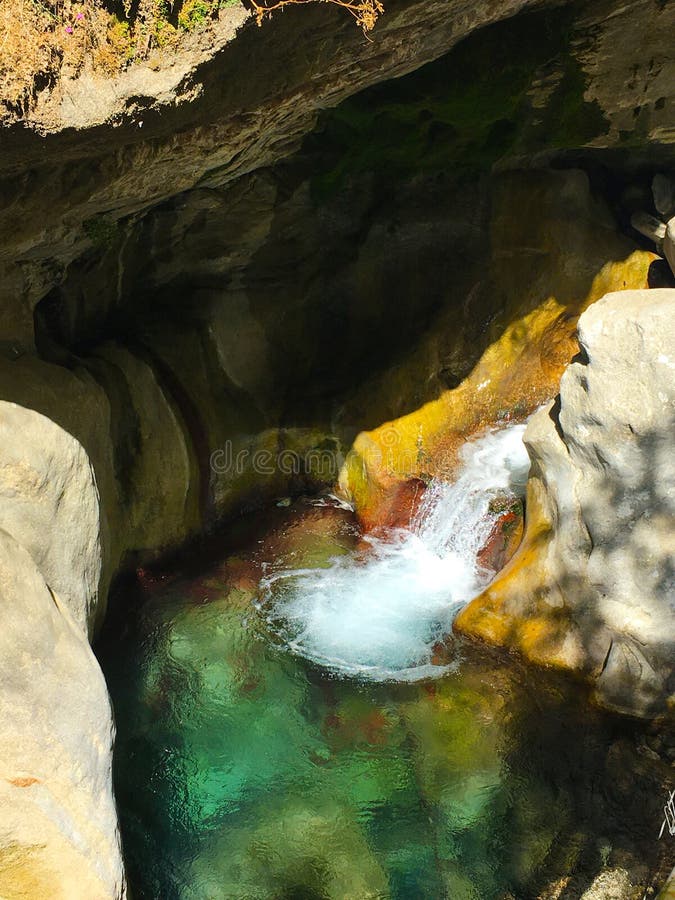 Aerial View of Cascading Waterfall Flowing into Forested Pool Below ...
