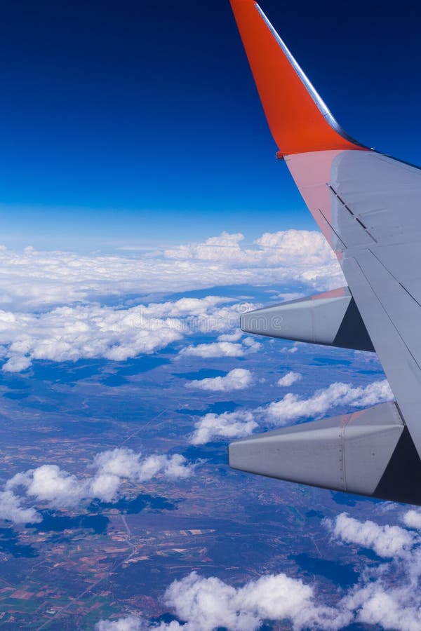Aerial View of Cloud Blue Sky and Plane Wing View through the Airplane ...