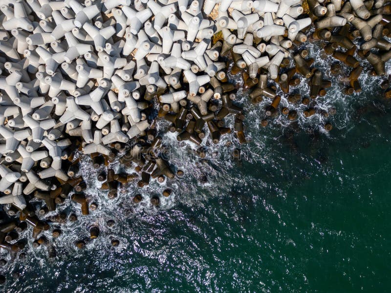 Aerial View of Concrete Tetrapod Wave Breakers Along a Rugged Shoreline ...