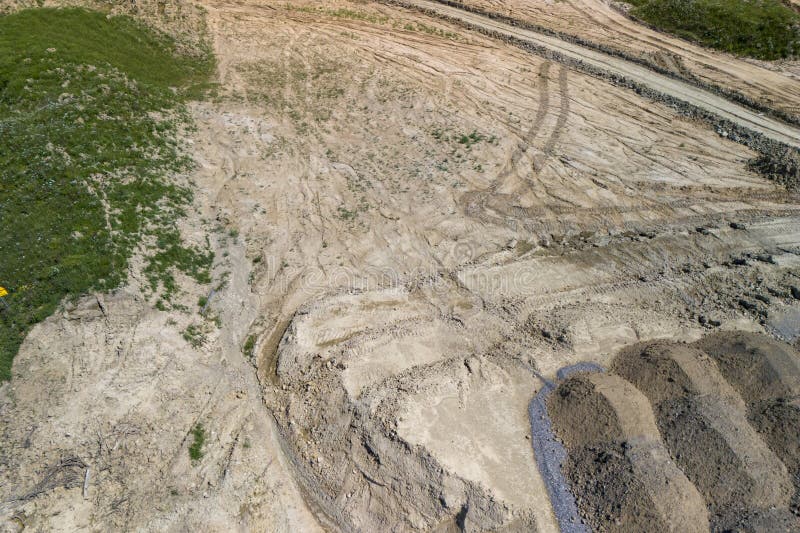 Aerial View of a Construction Site with Dirt Tracks and Patches of ...