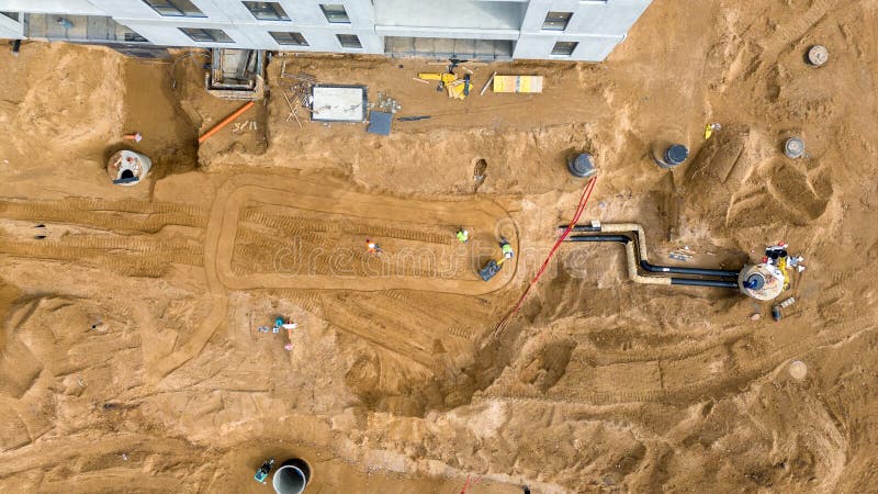 Aerial View of Construction Site with Groundwork and Pipe Installation ...