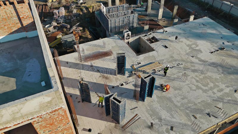 Aerial View of a Construction Site, Workers Assembling Formwork on a ...