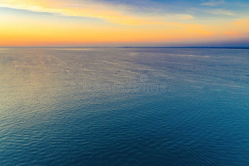 View of Dawn Over Ocean with Distant Coastline. Stock Image - Image of ...