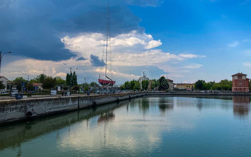 Aerial View of Dock Surrounded by Buildings with Reflection in Water in ...
