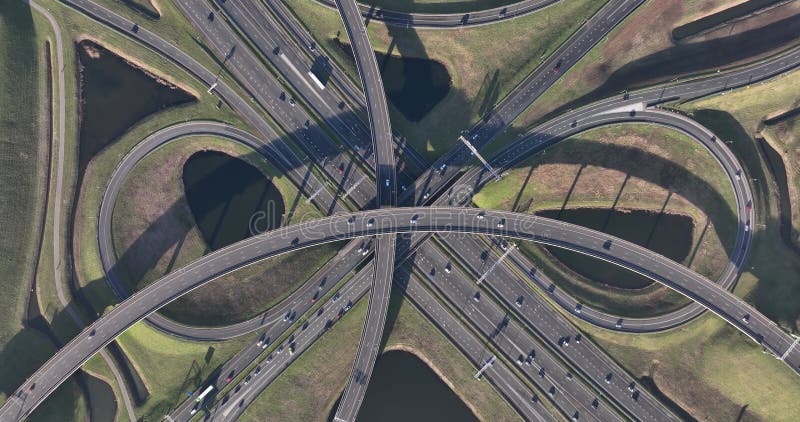 An Aerial Drone Captures the Busy Traffic at a Multi-level Highway ...