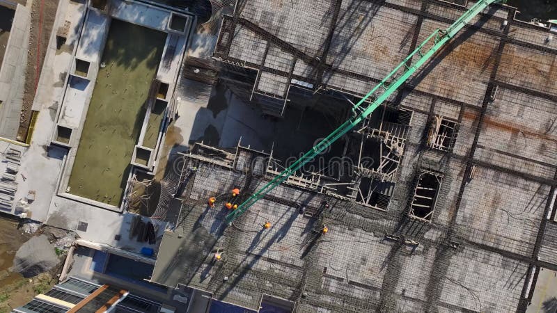 Aerial View: a Dynamic Team of Engineers and Workers Pours Concrete on ...