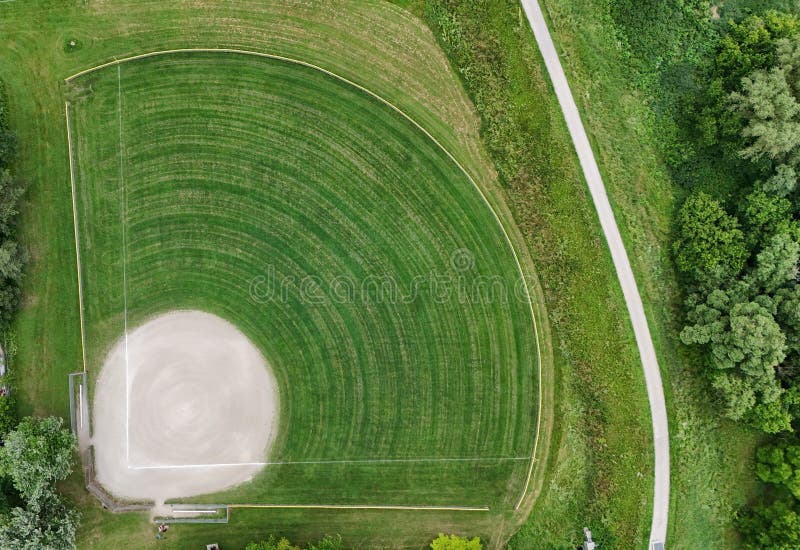 Aerial View of an Empty Baseball Field Surrounded by Greenery and a ...