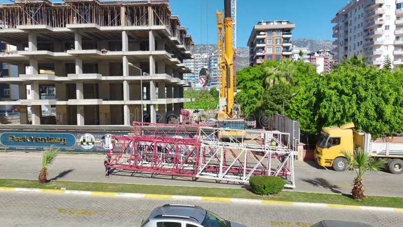 Aerial View: Engineers Guide the Installation of a Towering Crane As ...