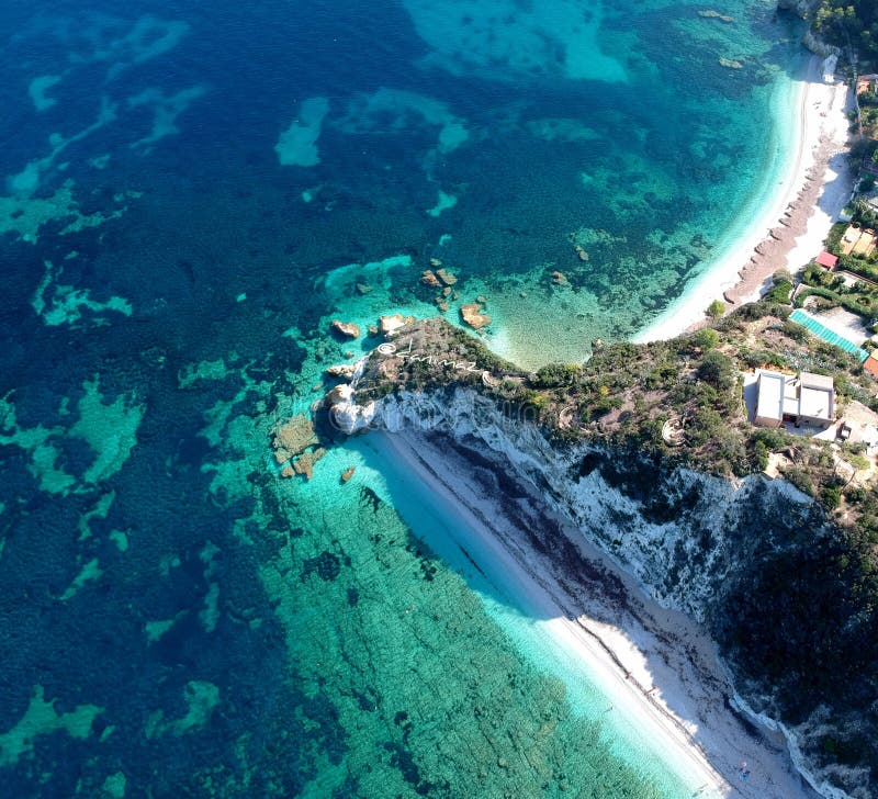 Aerial View of an Evergreen Cliff in the Middle of the Blue Ocean Stock ...